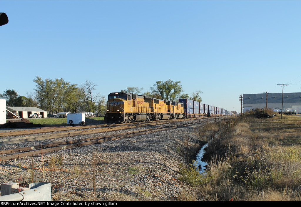 Up 4701 heads west with a stack train in tow.